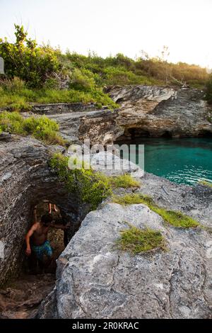 BERMUDA. Hamilton Parish. Cliff jumping, swimming off a point in ...