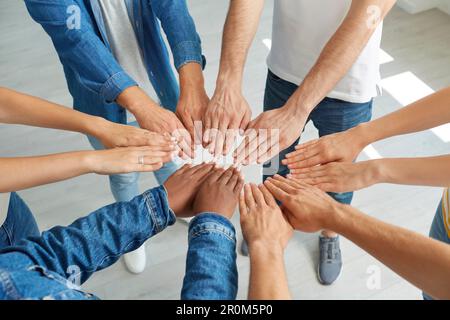 People putting hands together as symbol of unity Stock Photo - Alamy