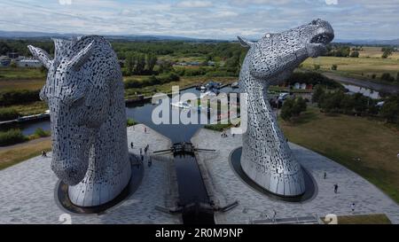 An aerial shot of a sculpture of two horseheads, The Kelpies in the ...