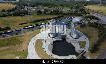 An aerial shot of a sculpture of two horseheads, The Kelpies in the ...