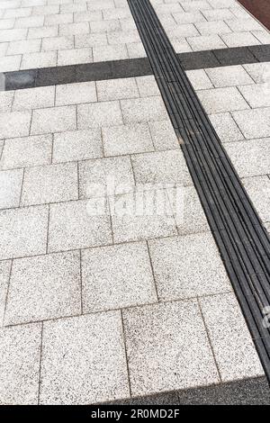 Textured walkway for blind people. Black tactile paving for the ...