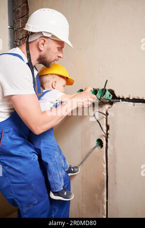 electrician mounting electric socket at building site Stock Photo - Alamy