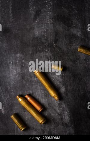 Empty bullet cartridges lying on the black background Stock Photo - Alamy