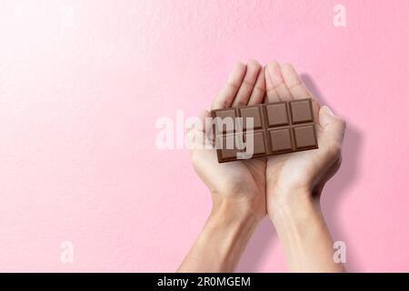 Human hand holding chocolate bar isolated over white background Stock ...