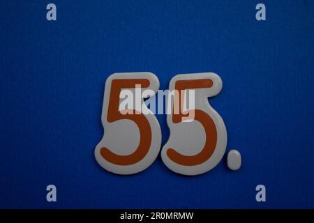 The number 55, orange and light blue, photographed from above, placed ...