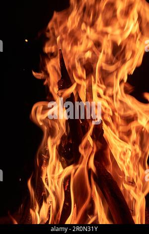 Dangerous huge flames of red fire, motion blur clouds of dark smoke ...