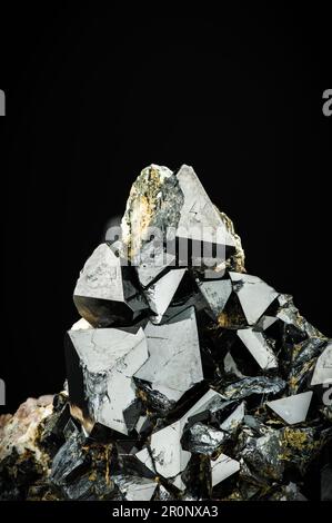 Magnetite (natural magnet) crystal macro detail white isolated ...