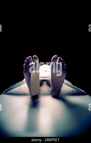 Dead body on mortuary table with name tag on toe Stock Photo - Alamy