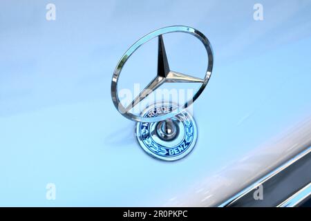Closeup of old original metal star logo of Mercedes Benz at hood of car ...