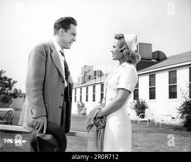 Director VINCENT SHERMAN and VIRGINIA MAYO on set location candid during filming of BACKFIRE ...