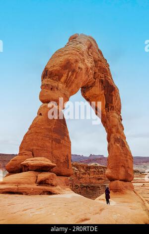 Tourists at Delicate Arch in Arches National Park, Canyon lands ...