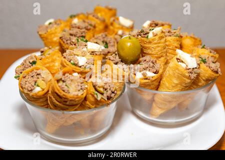 Traditional party snack known as "canudinho"or "tatu tail". Stuffed ...