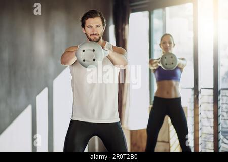 Young Woman And Man Working With Kettle Bell In A Gym - Kettle-bell ...