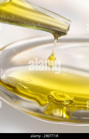 Olive Oil, Falling in a Spoon against Black Background Stock Photo - Alamy