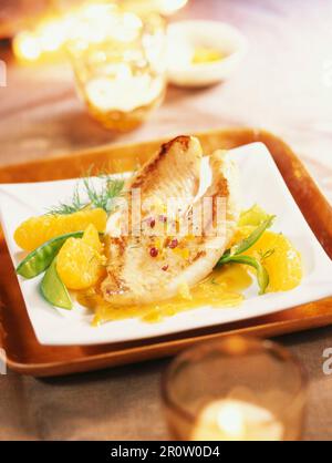 Fried John Dory fish fillet with vegetable and baguette as top-view in ...