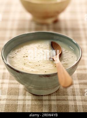 Cauliflower Soup (Creme du Barry) in black bowl on white background ...