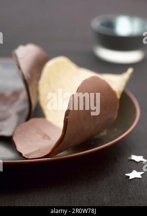 Nutty chocolate with hazelnuts on gray background Stock Photo - Alamy