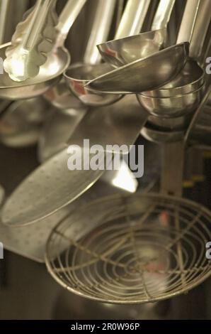 Hanging cooking implements Stock Photo - Alamy