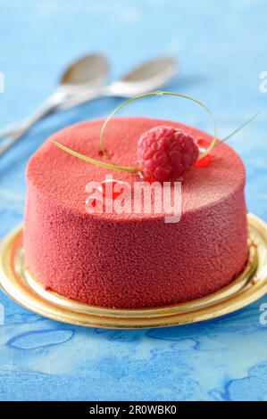 Small raspberry and raspberry mousse cake on white background Stock ...