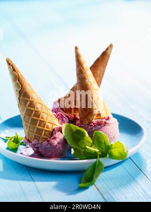 three raspberry ice cream cones with blue background Stock Photo - Alamy