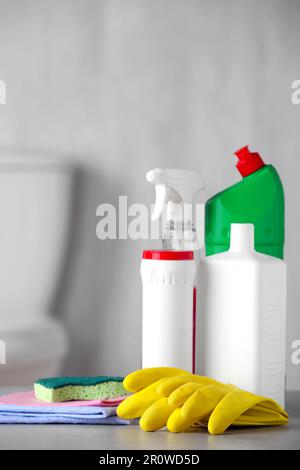 Set of cleaning supplies on table in room Stock Photo - Alamy
