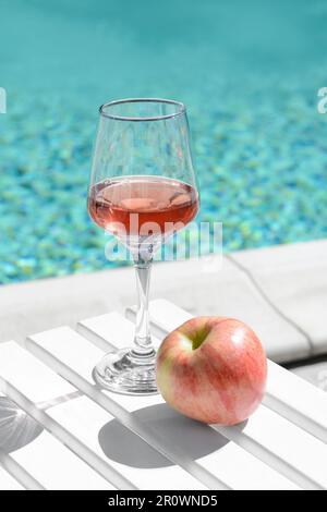 Glass of rose wine by the edge of a swimming pool at a pool party Stock ...