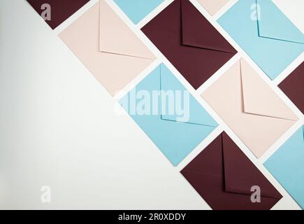 Top view of blue and pink envelopes near serpentine and sprinkles on ...