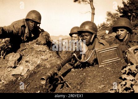 A US Army machine gun crew sets up an overwatch position during a foot ...
