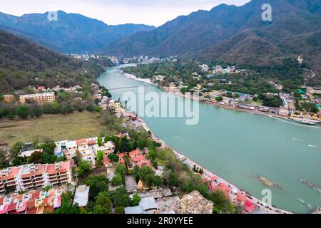 aerial drone shot over ram setu jhula suspension bridge with temples on ...