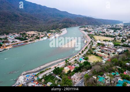 aerial drone shot over ram setu jhula suspension bridge with temples on ...