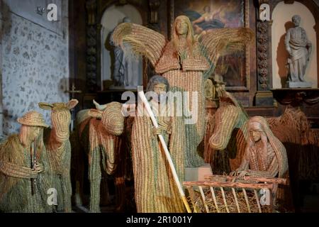 view of a beautiful straw nativity scene inside a church at Christmas ...