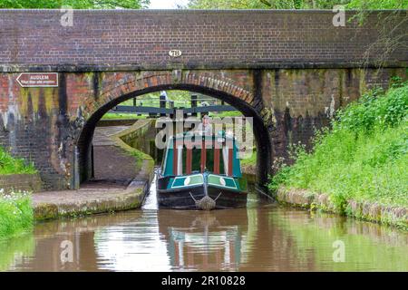 Canal narrowboat passing under bridge no 78 on the Shropshire union ...