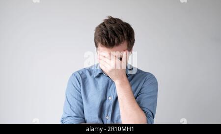 European young man barely holding back tears from problems and stress ...