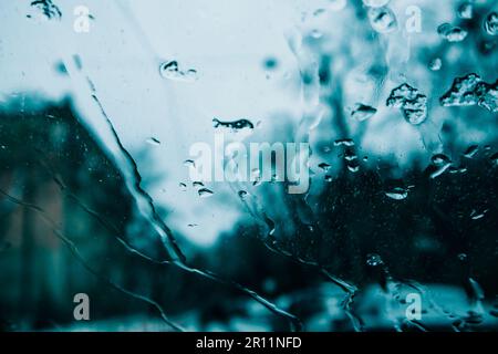 Car windshield with streams of water, melted snow in a cold autumn ...