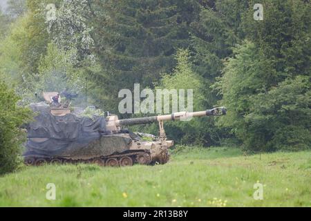 Hohenfels, Germany. 11th May, 2023. A soldier walks through the mud ...