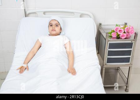 Child undergoing chemotherapy. A young cancer patient undergoing ...