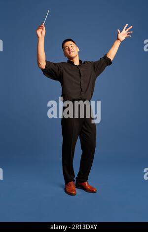 Happy professional conductor with baton on white background Stock Photo ...