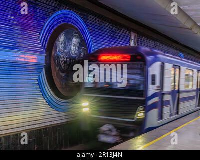 slow shutter photo of moving train arriving at alisher navoi metro ...