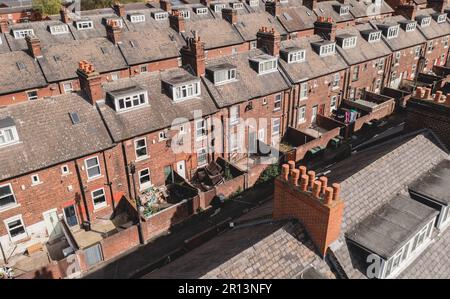 An aerial view above the rooftops of run down back to back terraced ...