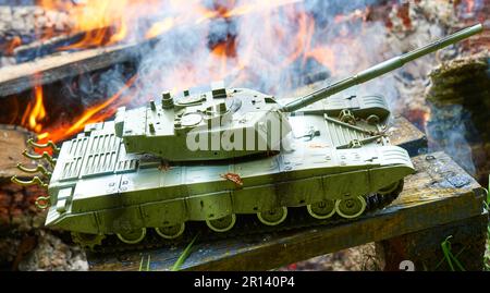 Plastic model tank on a bonfire Stock Photo - Alamy