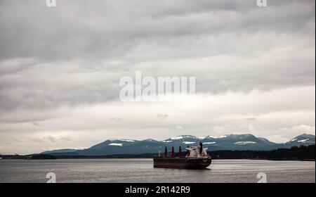 An ocean going cargo ship sits at its mooring outside of Nanaimo BC to ...