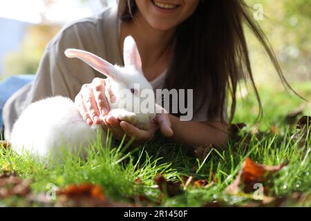Happy woman with white baby rabbit. Smiling Girl with little Easter ...