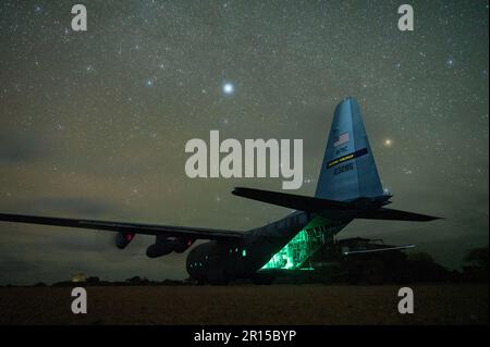 Cargo is offloaded from a C-130H assigned to the 75th Expeditionary ...