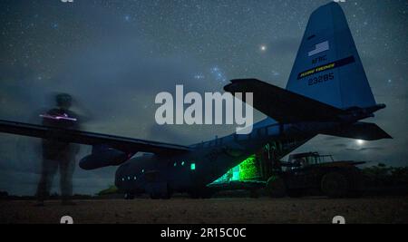 Cargo is offloaded from a C-130H assigned to the 75th Expeditionary ...