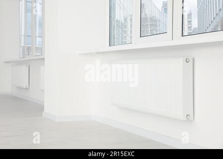 Modern office room with radiators and windows. Interior design Stock ...