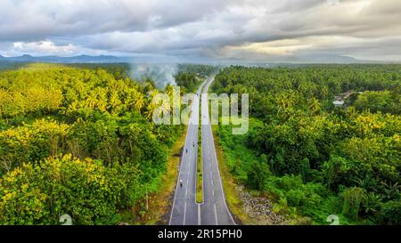Aerial photo of the highway dividing the forest and villages with a ...