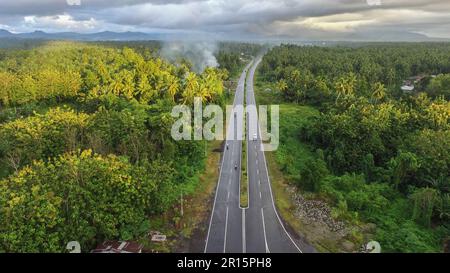 Aerial photo of the highway dividing the forest and villages with a ...