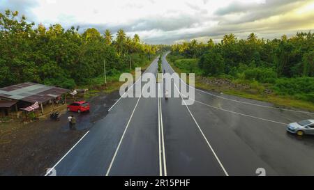 Aerial photo of the highway dividing the forest and villages with a ...