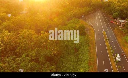 Aerial photo of the highway dividing the forest and villages with a ...