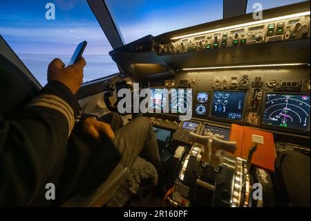 The pilot uses a smartphone while flying the plane. Autopilot Stock ...